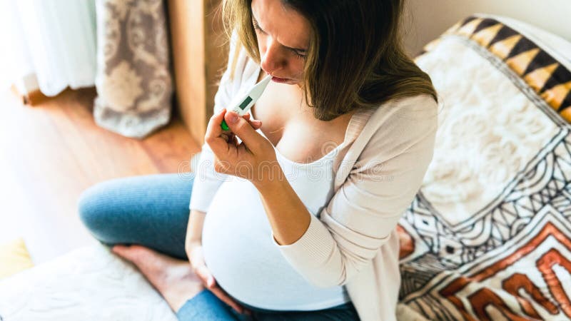 Pregnancy Fever Temperature Check. Pregnant Woman Holding Thermometer ... Pregnancy Fever Temperature Check. Pregnant Woman Holding Thermometer ...