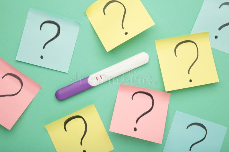 Pregnancy Test With Two Stripes With Question Marks On Mint Background