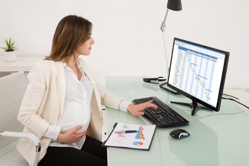 Pregnant Businesswoman Using Computer at Desk in Office Stock Image ...
