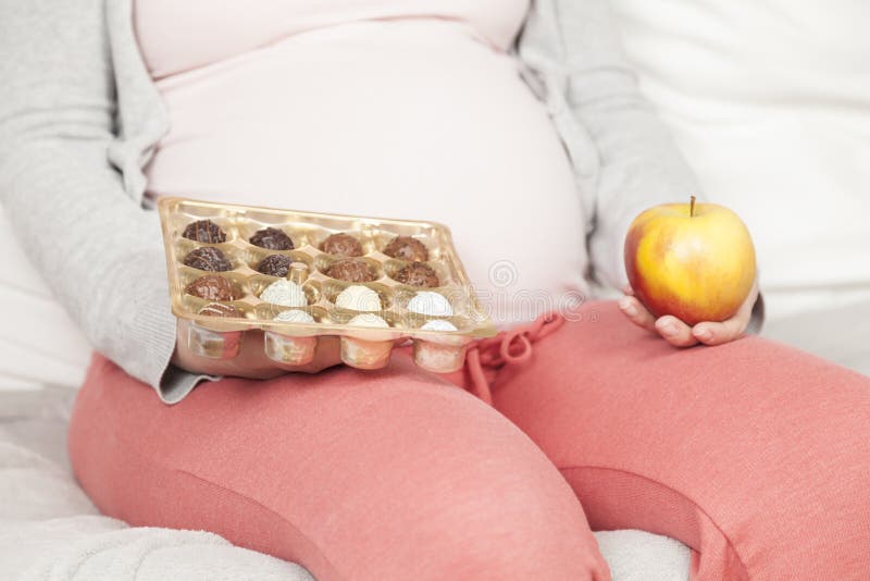 Pregnant with Candy and Apple Stock Photo - Image of chcolate ...