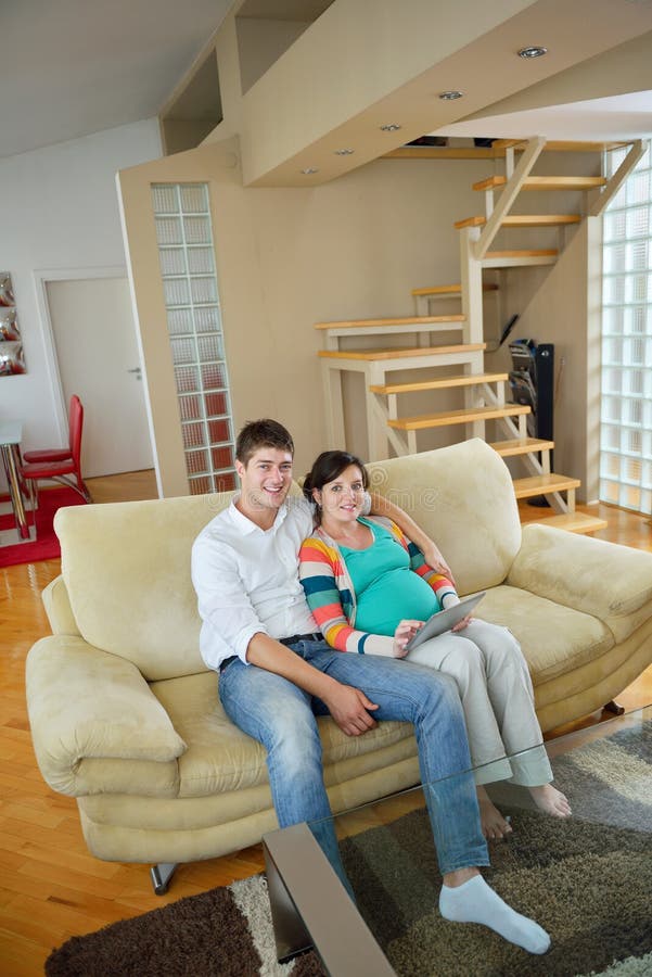 Pregnant Couple at Home Using Tablet Computer Stock Image - Image of ...