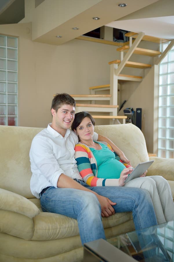 Pregnant Couple at Home Using Tablet Computer Stock Photo - Image of ...