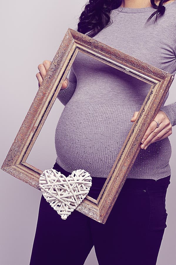 Pregnant Woman Holding a Frame Withs Heart Stock Image - Image of ...