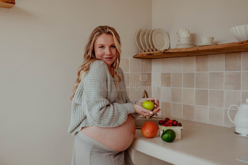 Pregnant Woman in the Kitchen with Fruits Stock Photo - Image of people, pregnancy: 297614394
