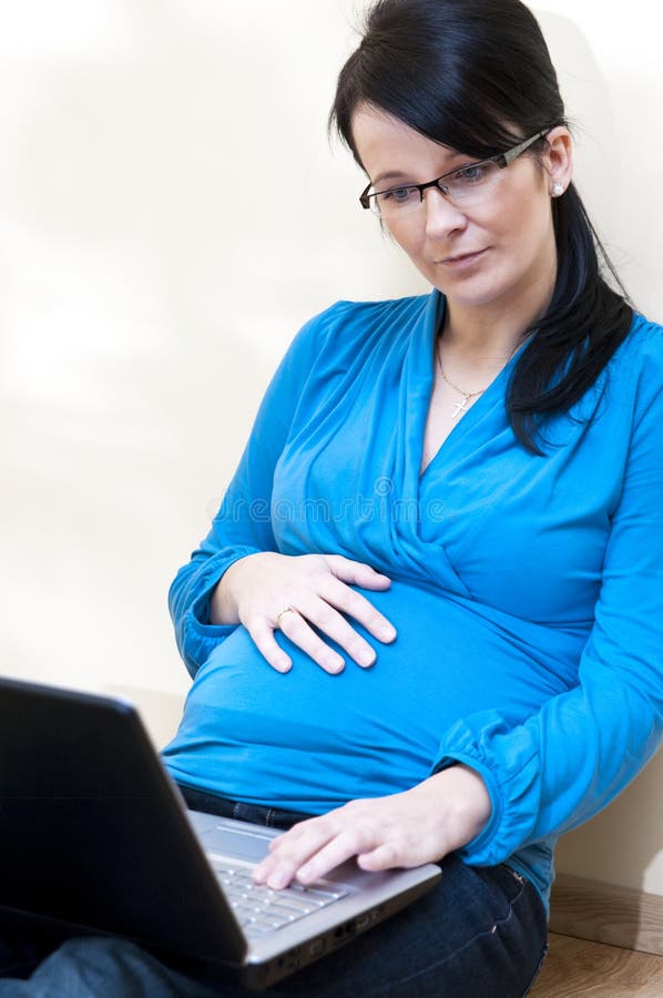 Pregnant woman and laptop stock photo. Image of surf - 12305906