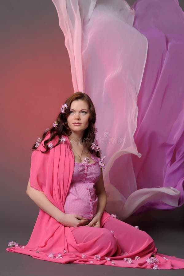 Pregnant woman in the pink stock image. Image of hands - 93455423