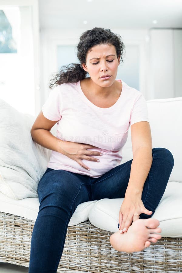 Pregnant Woman Touching Feet While Holding Belly Stock Image Image Of