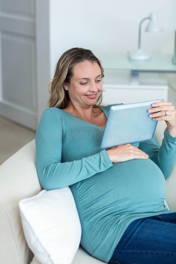 Pregnant Woman Using a Tablet Computer Stock Photo - Image of cheerful ...
