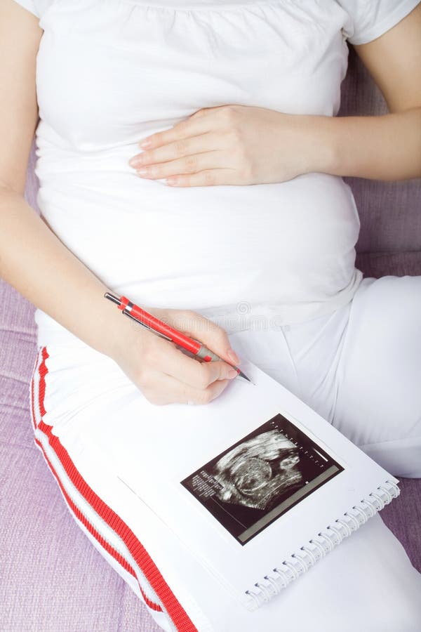 Pregnant Woman Writing Notes Stock Photo - Image of pregnancy, memo ...