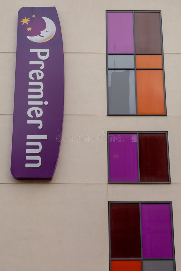 A Premier Inn Hotel Sign and Colourful Windows on the Side of a Premier ...