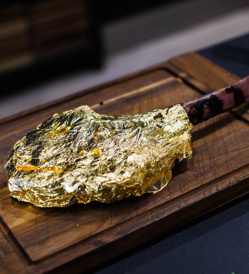 Premium Beef Tomahawk Coated in Edible Gold Stock Image - Image of ...