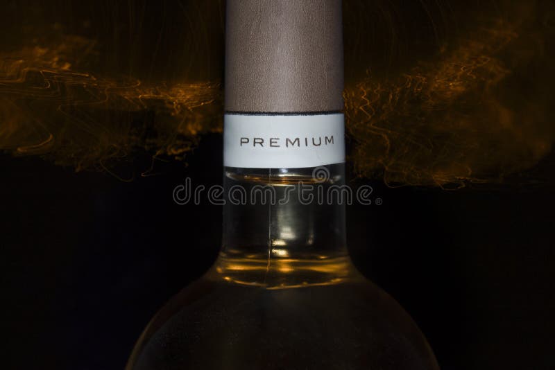 Premium Orange Bottle of Alcohol on Black Background Stock Photo ...