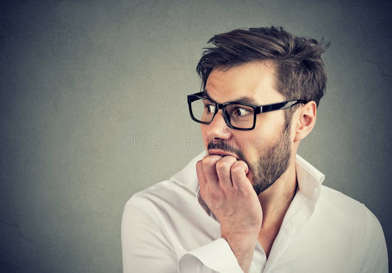 Preoccupied Anxious Man Biting His Fingernails Looking To the Side ...