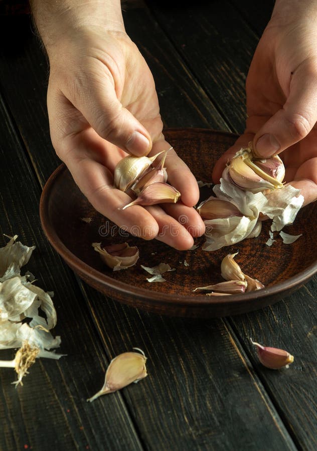 Preparation or Cleaning Garlic by the Hands of a Chef in the Restaurant ...