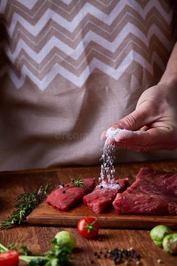 Strong Professional Man`s Hands Spilling Salt on Raw Beefsteak ...