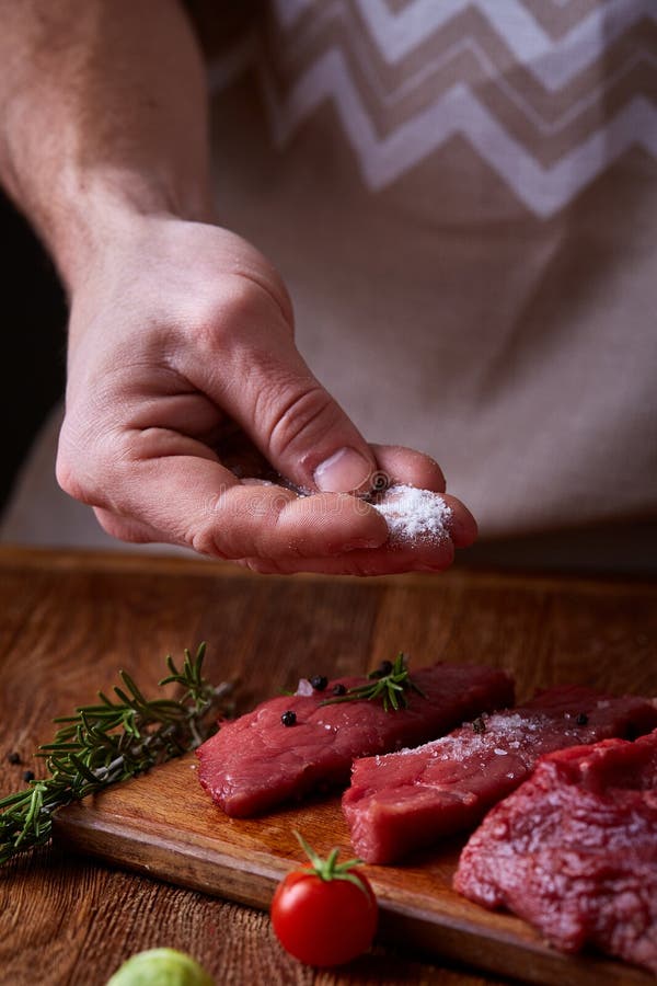 Strong Professional Man`s Hands Spilling Salt on Raw Beefsteak ...