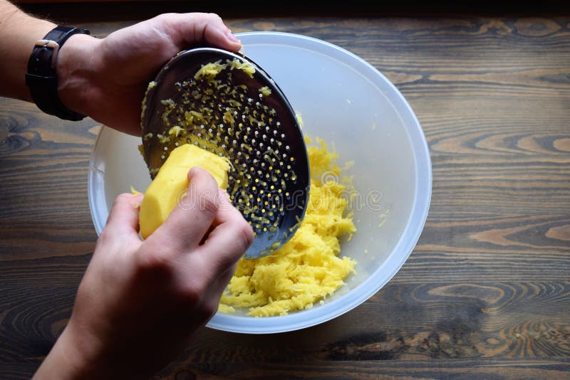 Grate The Potatoes. A Woman Is Rubbing Grated Potatoes. Natural Food ...
