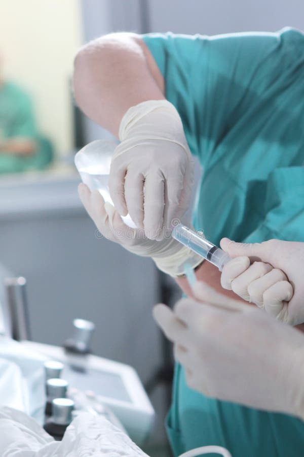 Preparation of the Injection. Syringe in Hands of Doctors. Operating ...