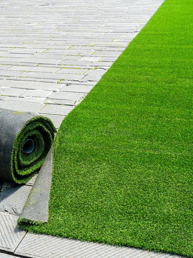 Preparing Artificial Grass Carpet Rolls for Outdoor Event Flooring in the Town Square Stock ...