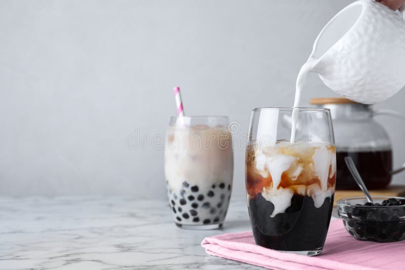Preparing Bubble Milk Tea with Tapioca Balls on White Marble Table ...