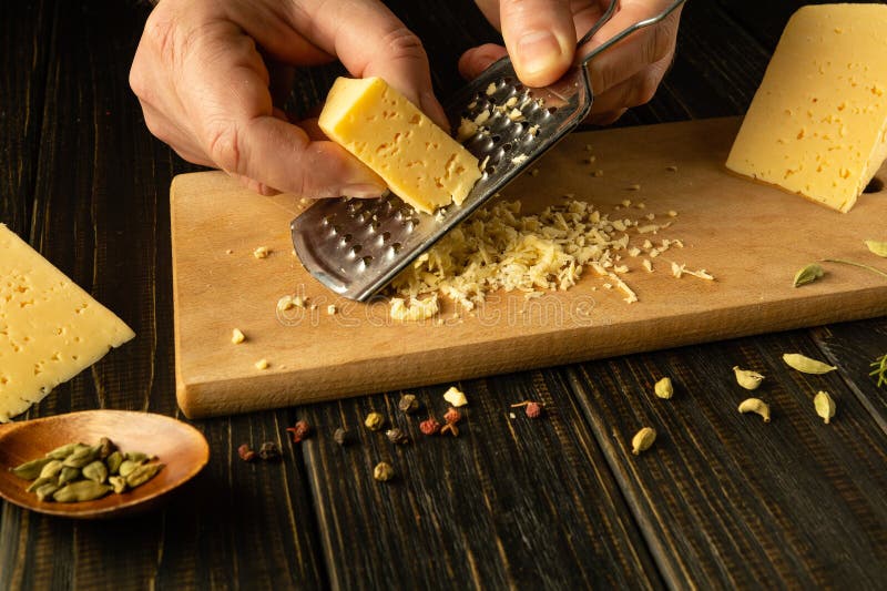 Preparing a Cheese Dish. a Grater in the Hands of a Chef for Grating ...