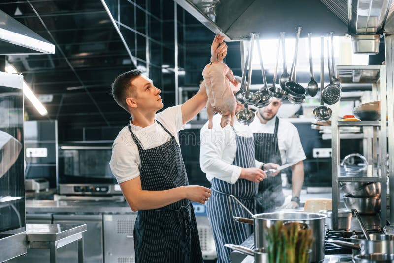 Preparing Chicken. Chef is on the Kitchen Making Food Stock Photo ...