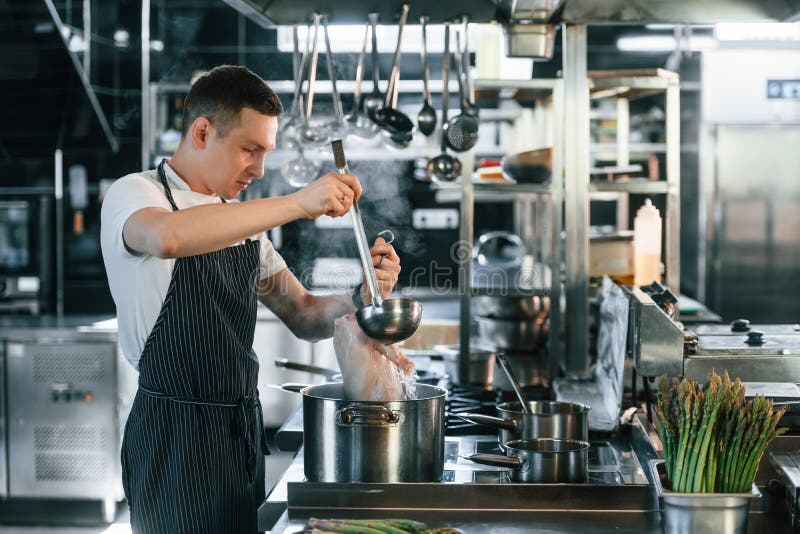 Preparing Chicken. Chef is on the Kitchen Making Food Stock Image ...