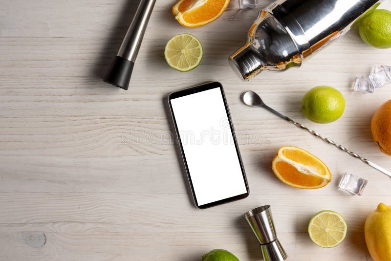 Preparing Cocktail at Home. Watching Recipe of Cocktail on Smartphone ...