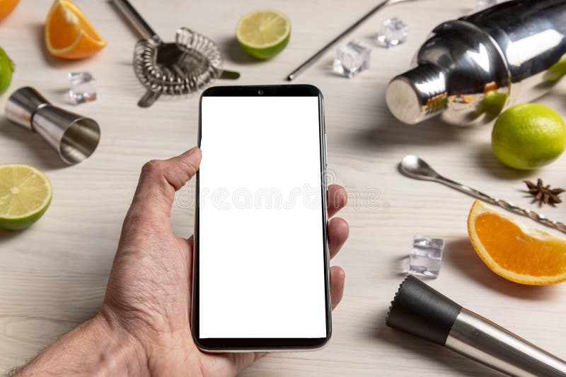 Preparing Cocktail at Home. Watching Recipe of Cocktail on Smartphone ...