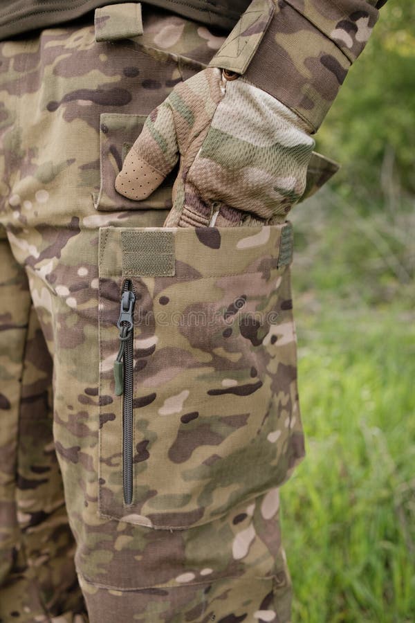 Preparing for Combat: Close-up of Soldier Putting on Gear in the Field ...