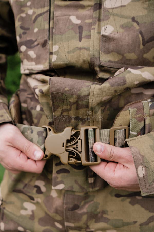 Preparing for Combat: Close-up of Soldier Putting on Gear in the Field ...