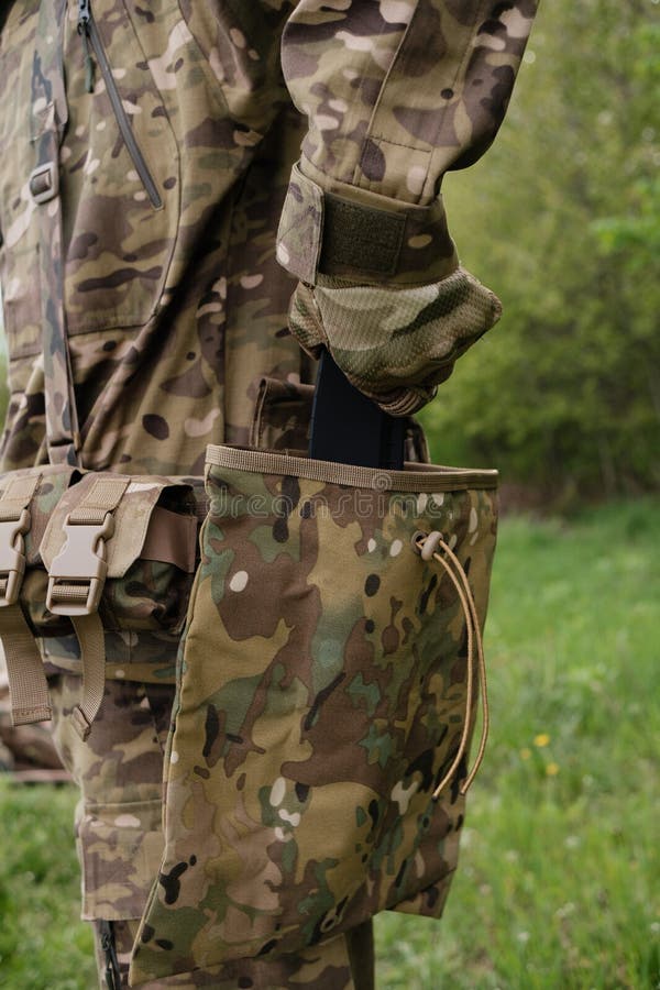 Preparing for Combat: Close-up of Soldier Putting on Gear in the Field ...