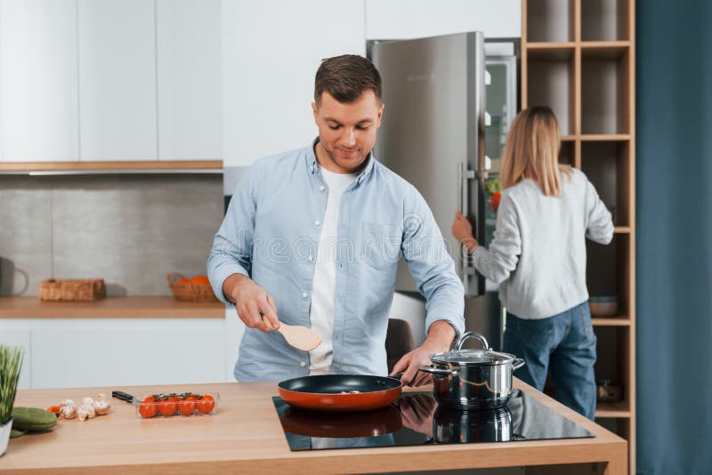 Preparing Dinner. Couple at Home on the Modern Kitchen Stock Photo ...