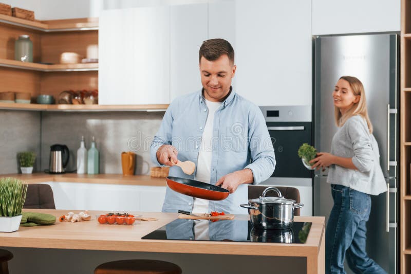 Preparing Dinner. Couple at Home on the Modern Kitchen Stock Photo ...