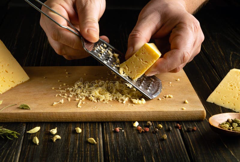 Before Preparing a Dish, the Chef Hands Grate Hard Milk Natural Cheese ...