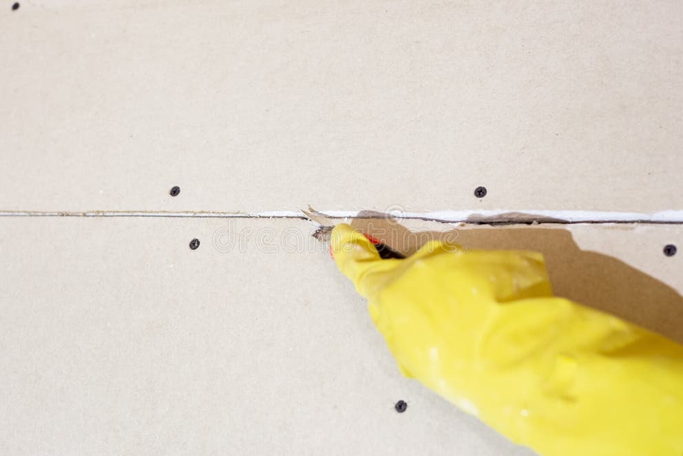 Preparing Drywall for Putty and Plaster. the Craftsman Cuts the Edge of ...