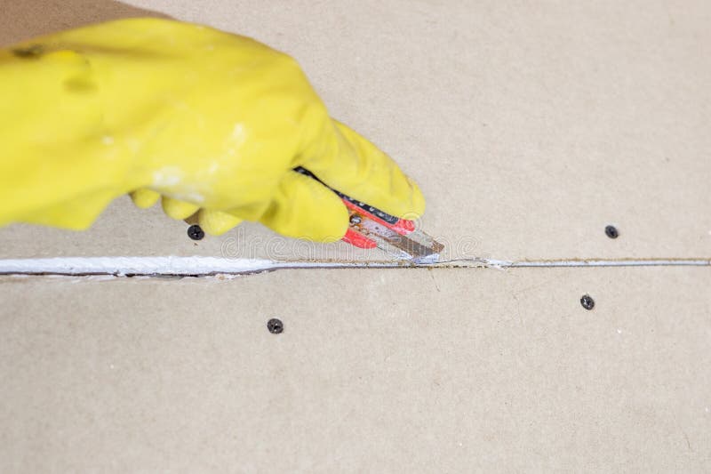 Preparing Drywall for Putty and Plaster. the Craftsman Cuts the Edge of ...