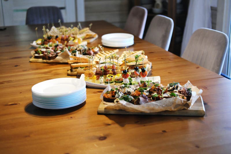 Preparing for a Family Dinner. Appetizers are Put on the Table and a ...