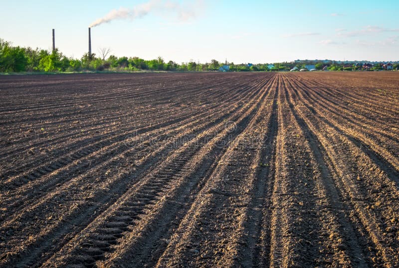 Preparing Field for Planting. Plowed Soil in Spring Time, Two Tubes ...
