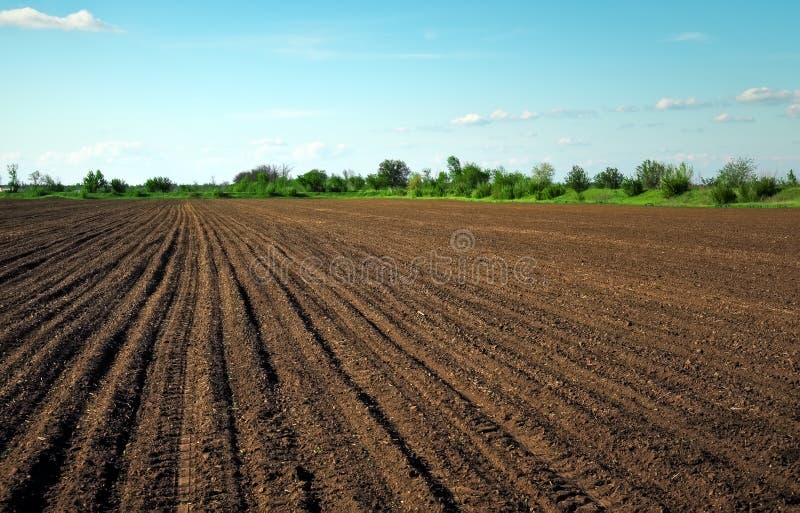 Preparing Field for Planting. Plowed Soil in Spring Time with Two Tubes ...