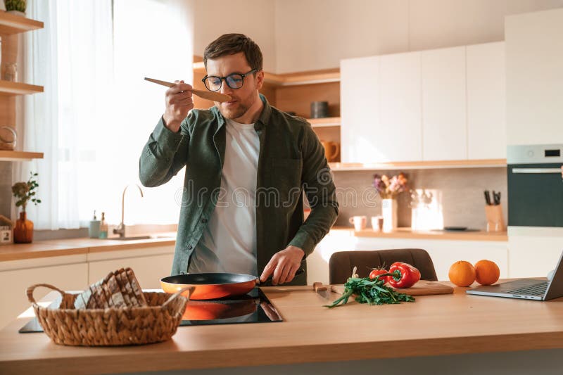 Preparing the Food. Handsome Man is on the Kitchen at Daytime Stock ...
