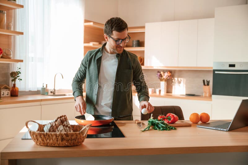 Preparing the Food. Handsome Man is on the Kitchen at Daytime Stock ...