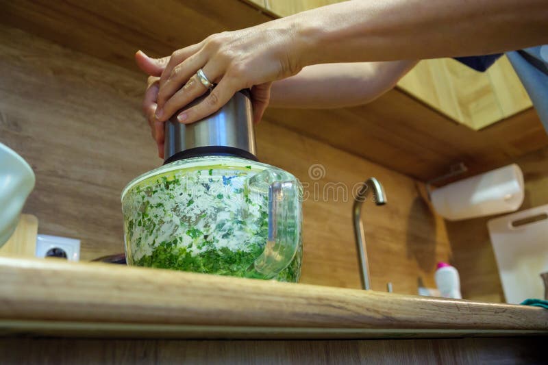 Preparing Fresh Herb Mixture in a Kitchen Using a Food Processor Stock ...