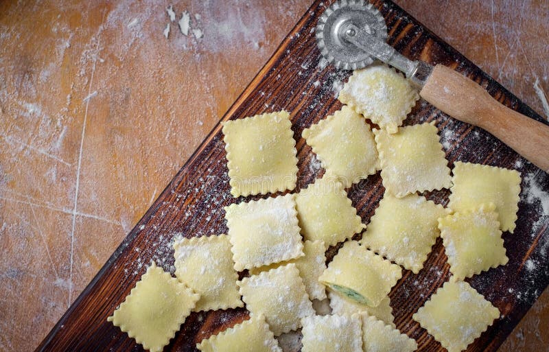 Preparing Fresh Homemade Ravioli at the Kitchen Table with Flour Stock ...