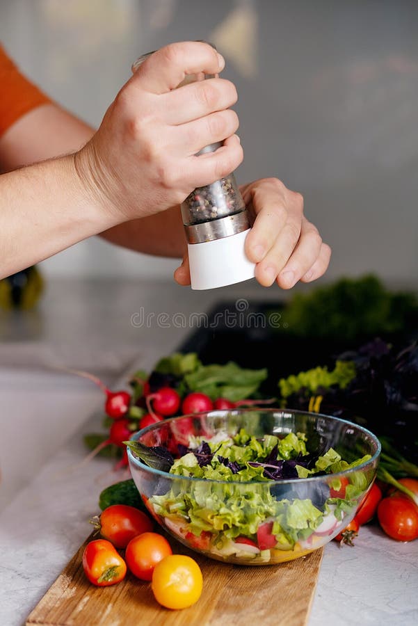 Preparing Healthy Salad in Kitchen, Adding Salt To the Bowl Stock Photo ...