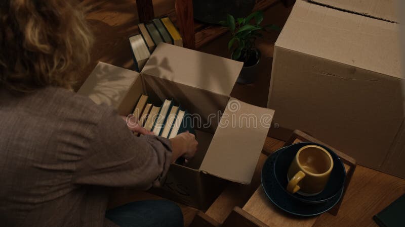 Preparing for Move, Removal Concept. Woman Packs Books into Moving ...