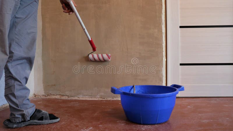 Preparing a Room Wall with a Primer Using Home Equipment Stock Photo ...
