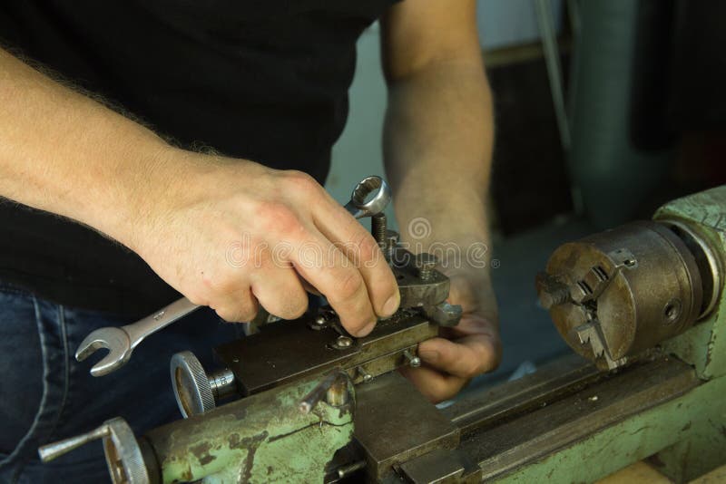 Working on a Lathe. Preparing and Setting Up the Machine. Hands of the ...
