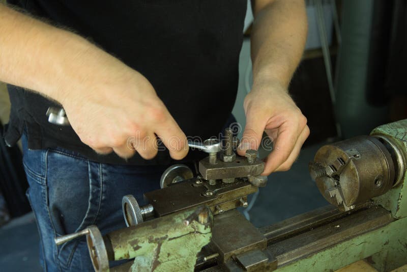 Working on a Lathe. Preparing and Setting Up the Machine. Hands of the ...
