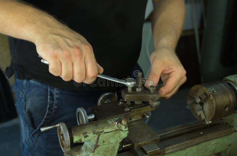 Working on a Lathe. Preparing and Setting Up the Machine. Hands of the ...
